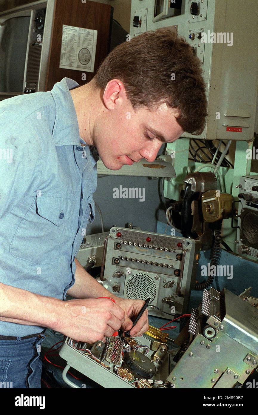 An interior communications electrician repairs an intercom aboard the ...