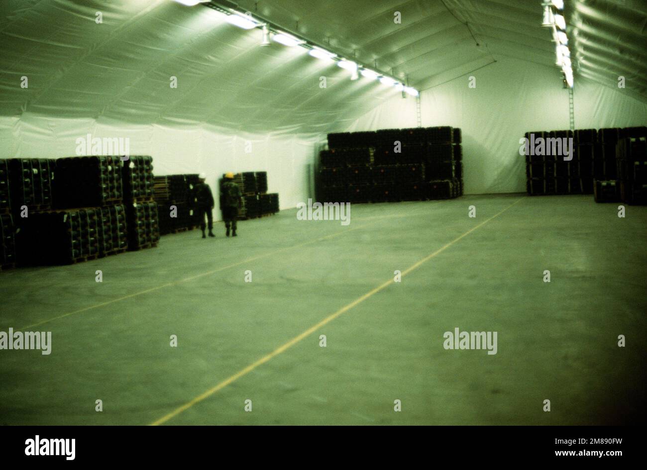 Crates of ammunition and other supplies are stacked inside an insulated ...