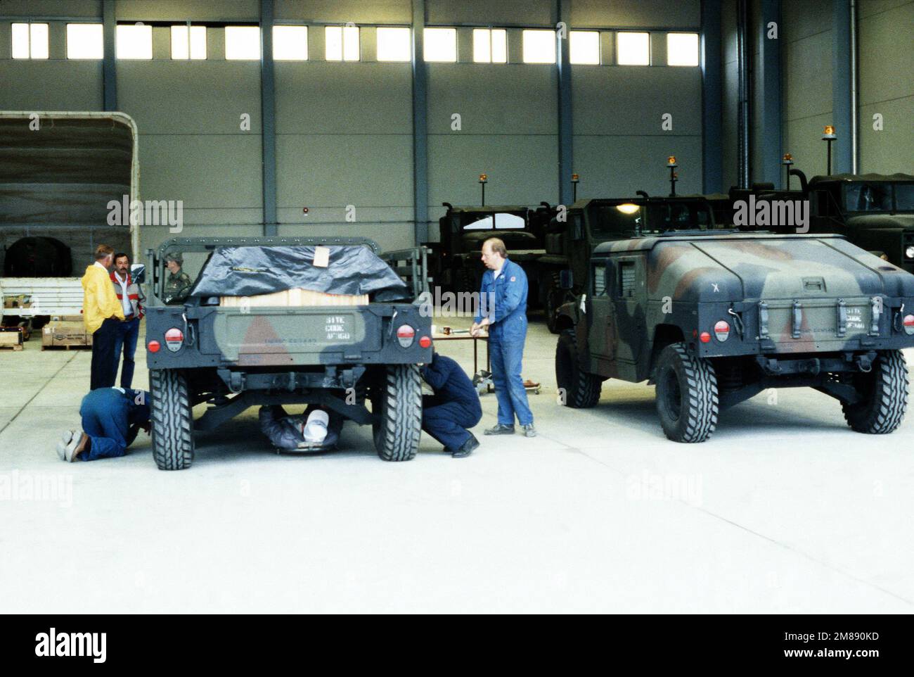 Maintenance personnel inspect an M998 High-Mobility Multipurpose ...