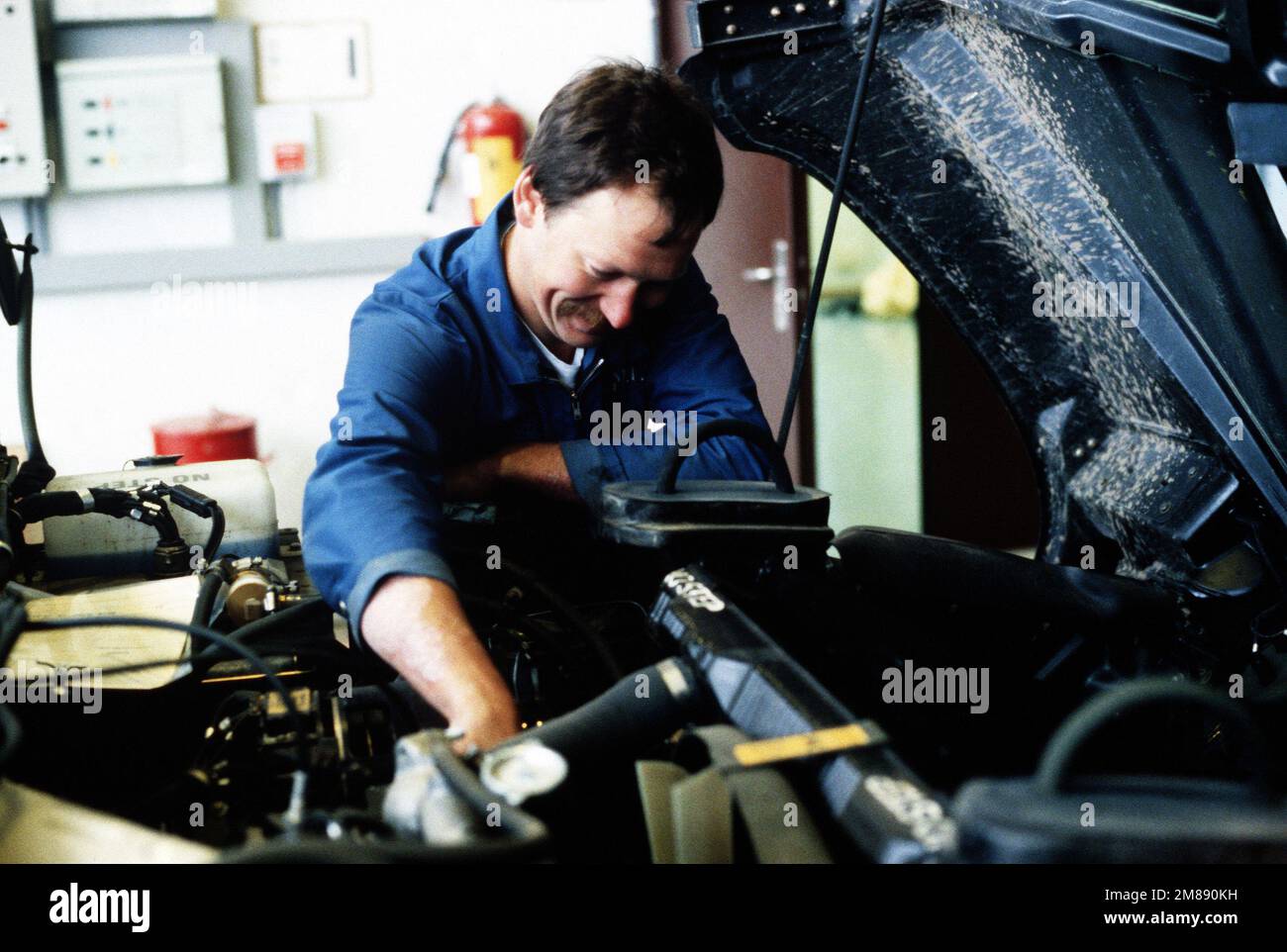 A mechanic inspects an M-998 High-Mobility Multipurpose Wheeled Vehicle ...