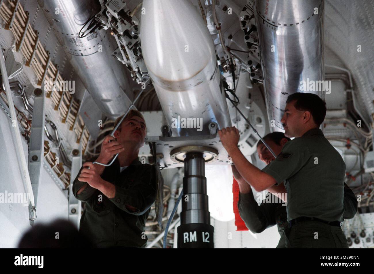 Members of the 28th Munitions Maintenance Squadron bolt a BDU-38 ...