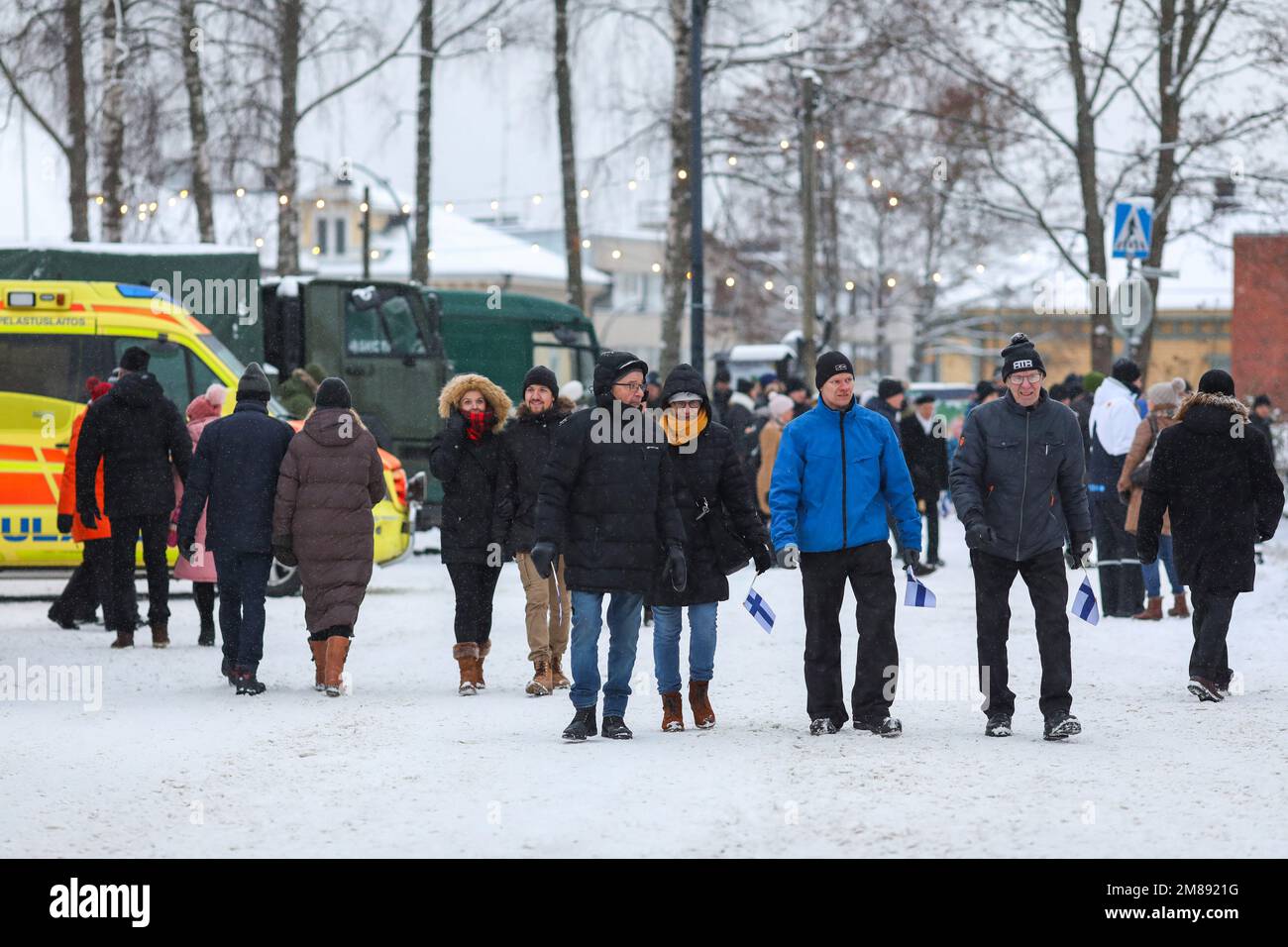 People with Finnish flags walk down the street during the Independence ...