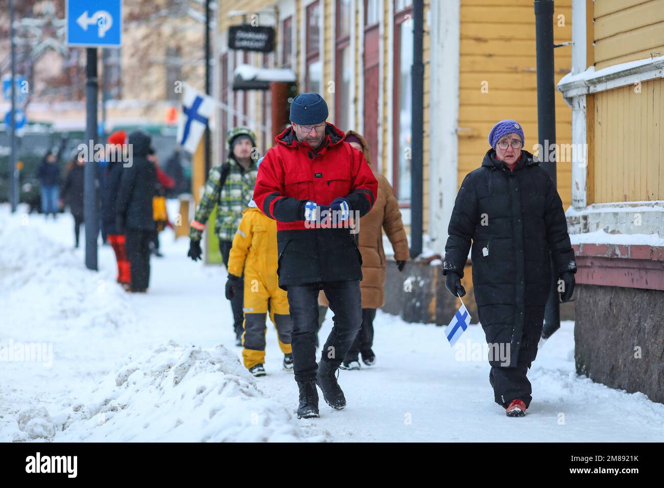 People with Finnish flags walk down the street during the Independence ...