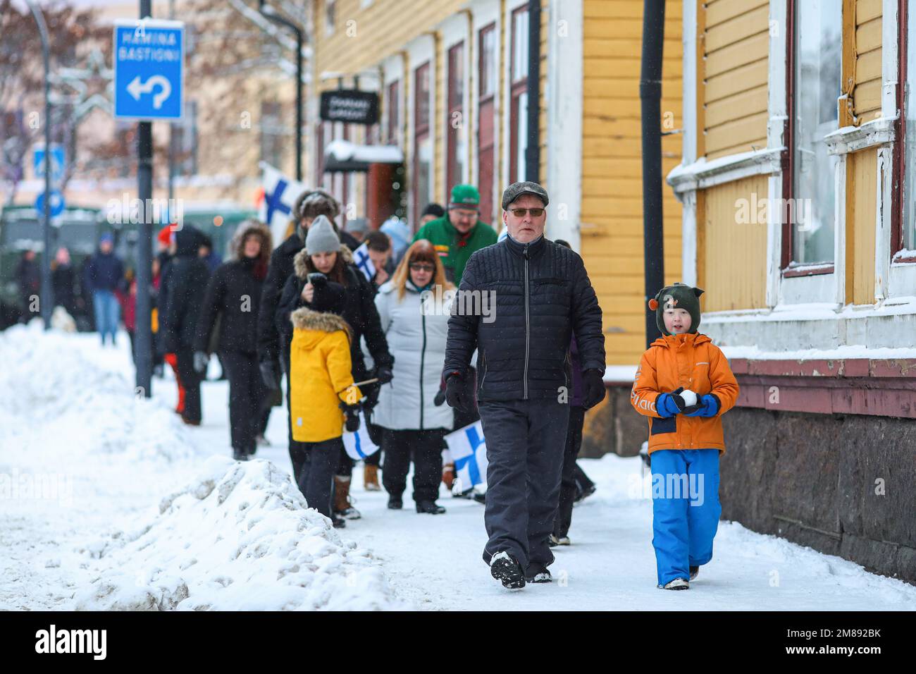 People with Finnish flags walk down the street during the Independence ...