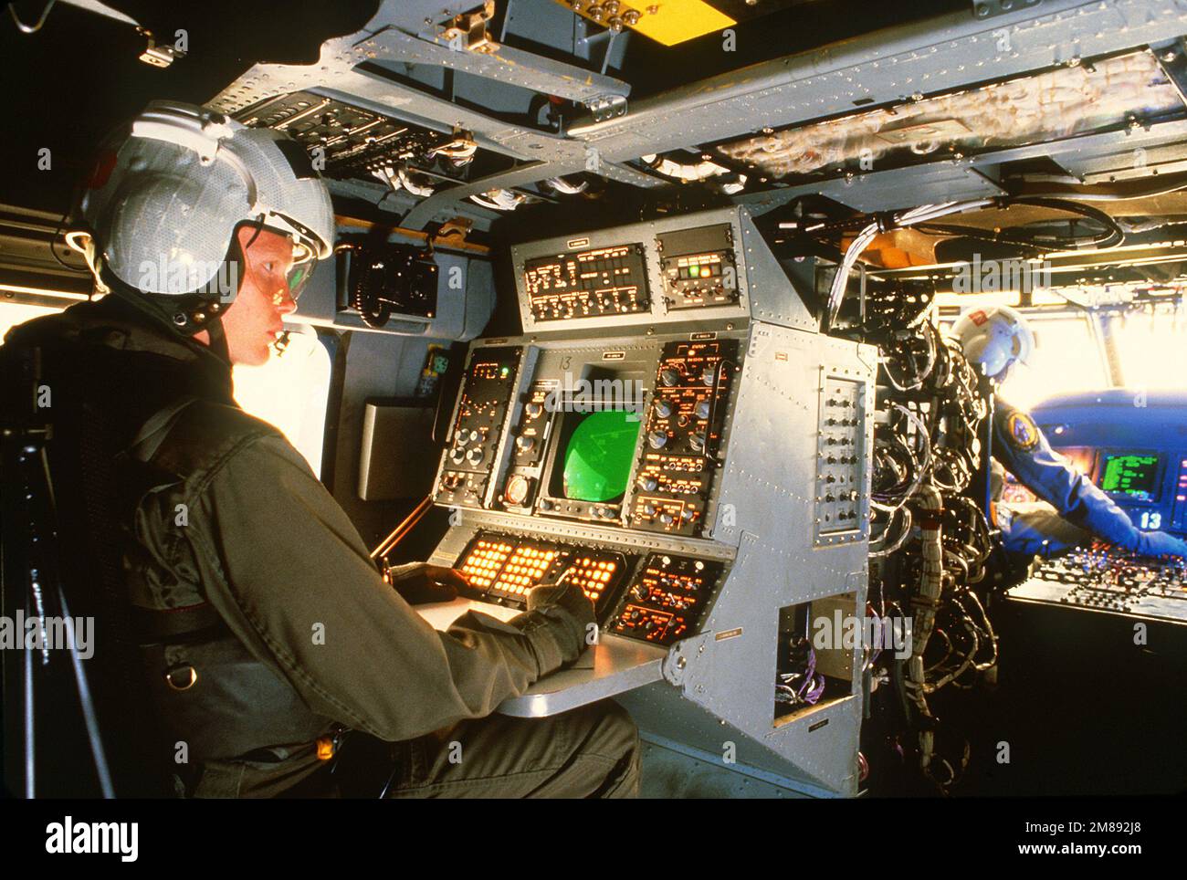 An aviation anti-submarine warfare operator at the controls of the ...