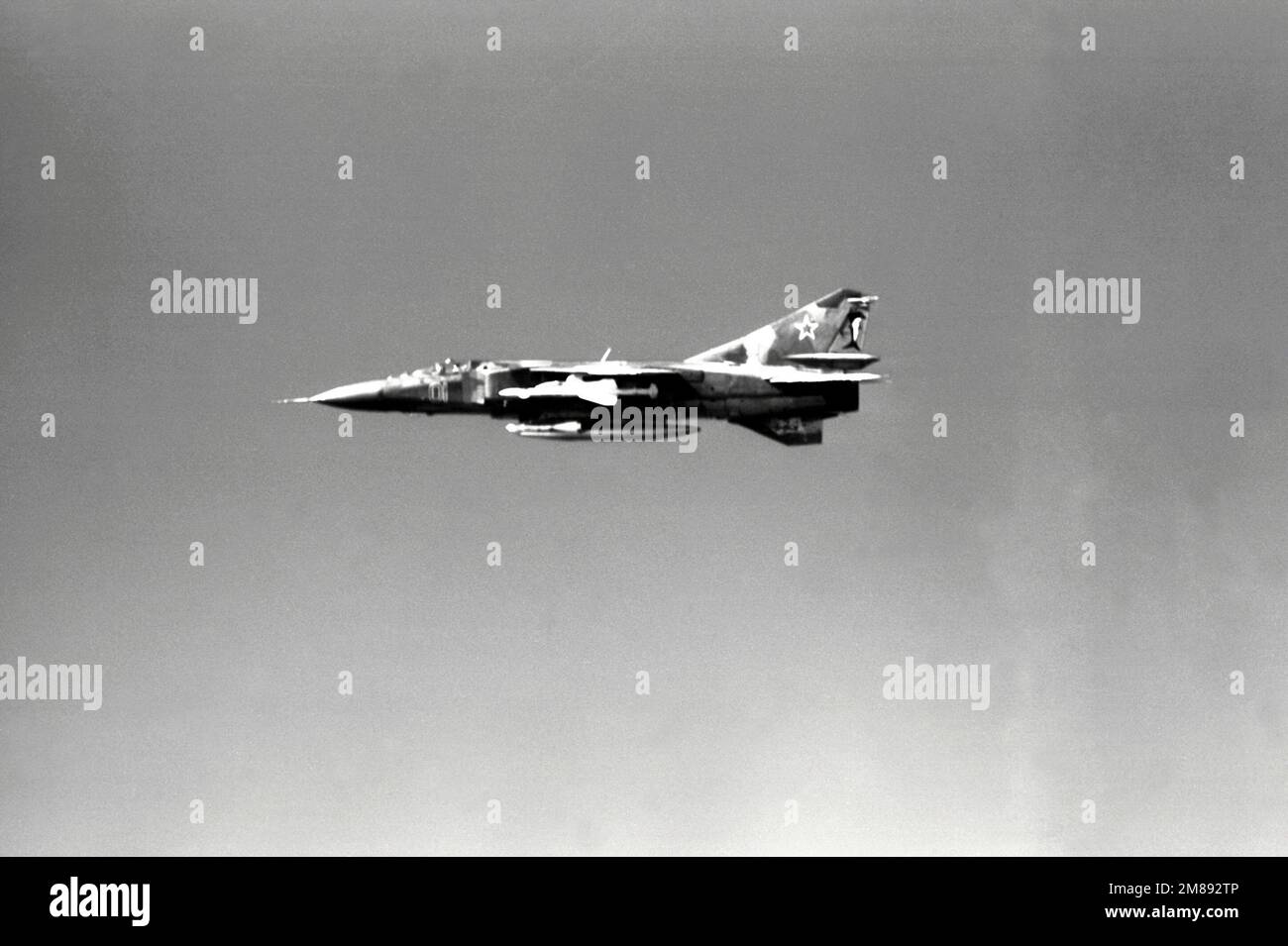 An air-to-air left side view of a Soviet MiG-23 Flogger aircraft ...