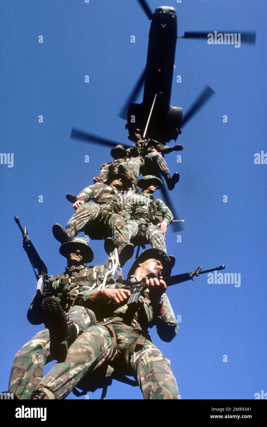 A CH-46 Sea Knight helicopter lifts a team of Marines off the ground ...