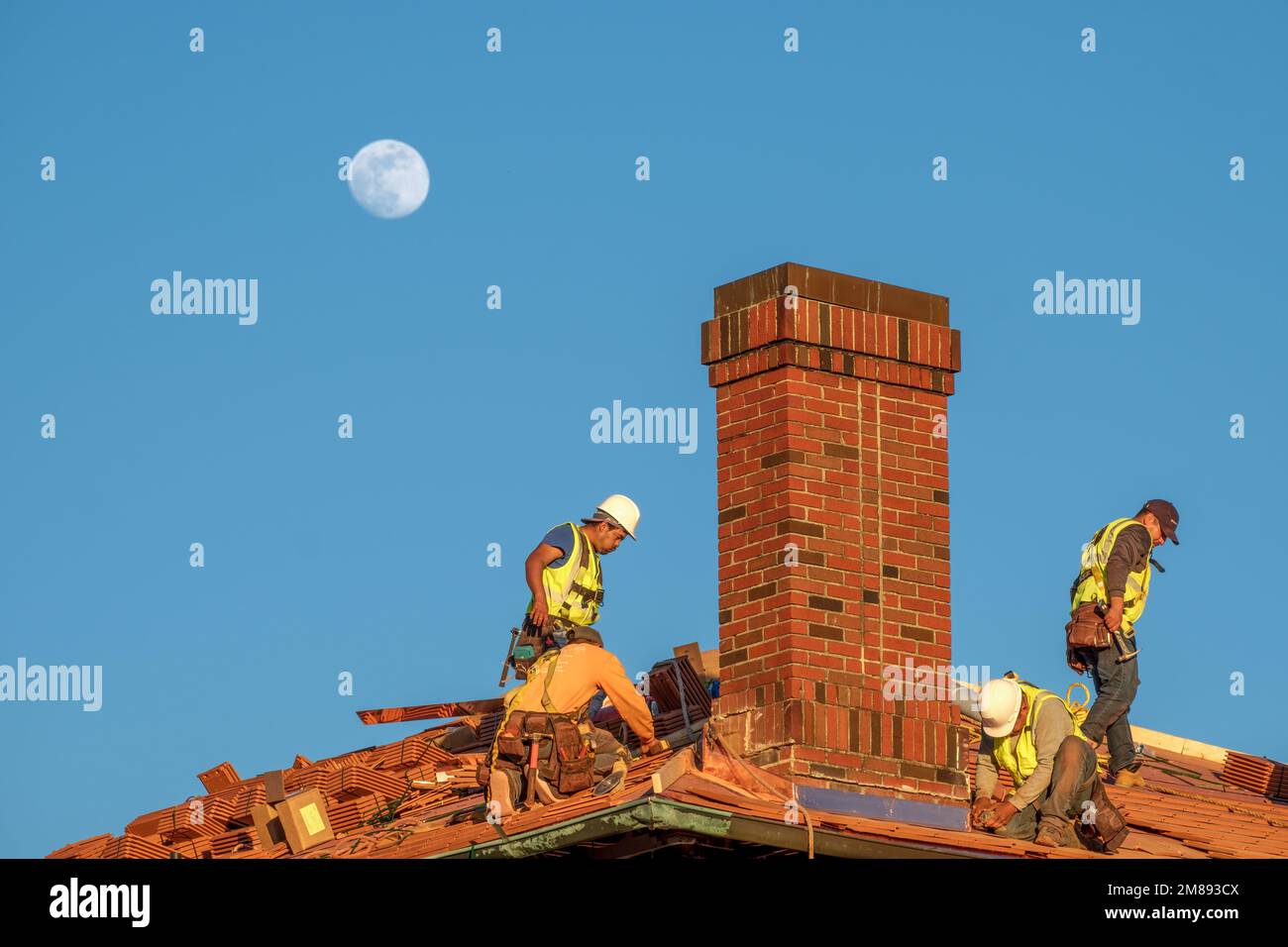 NEW ORLEANS, LA, USA - JANUARY 4, 2023: Roofers replace roofing tiles ...