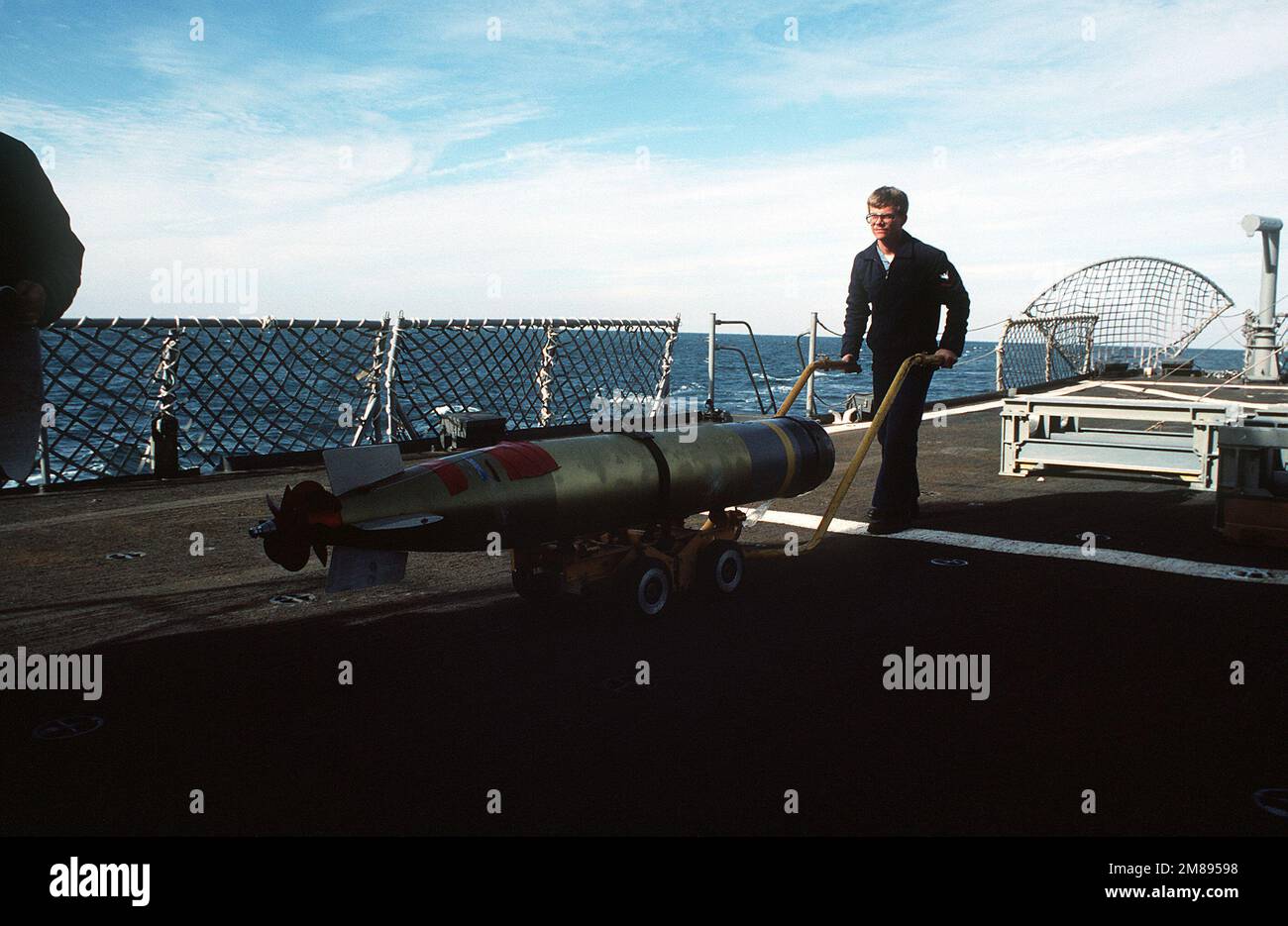 A petty officer moves a Mark 46 torpedo during a general quarters ...