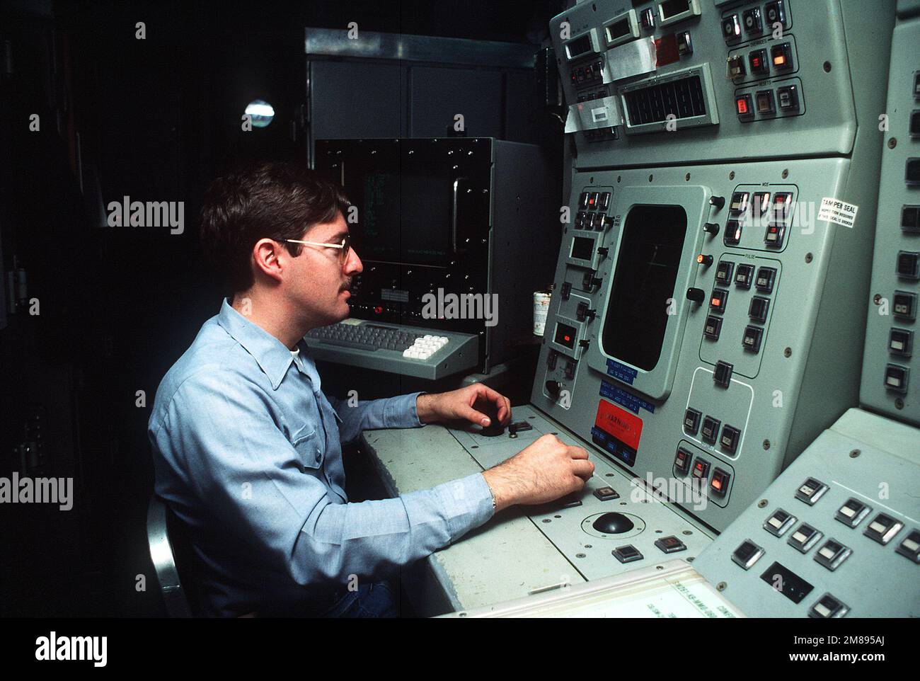 A petty officer mans a missile tracking system during a general ...