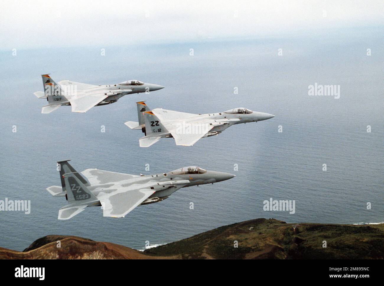 An air-to-air right side view of 12th Tactical Fighter Squadron F-15 ...