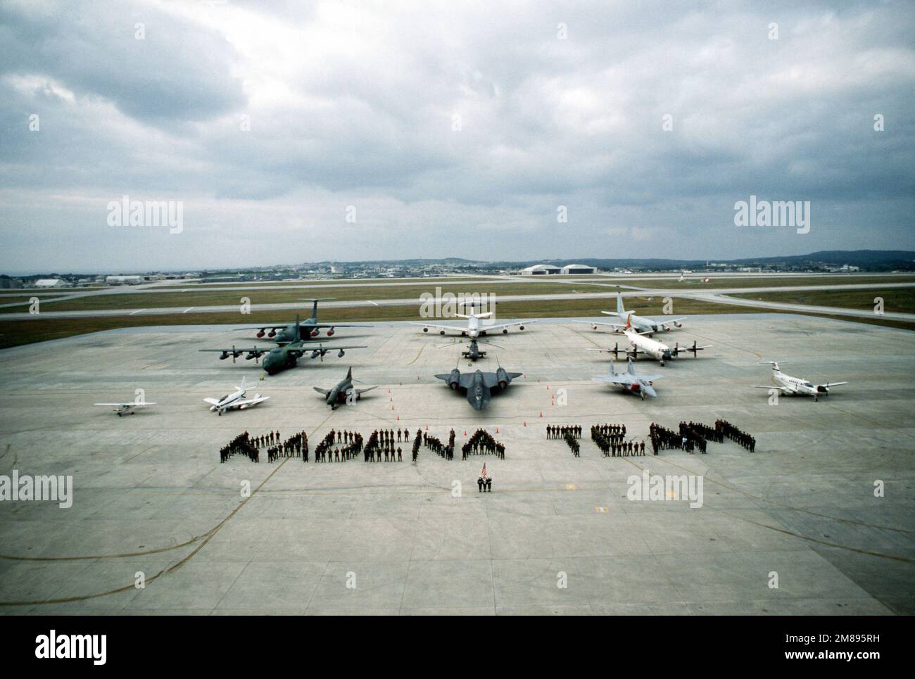 U.S. Air Force personnel stand in formation to spell out "Kadena Team ...