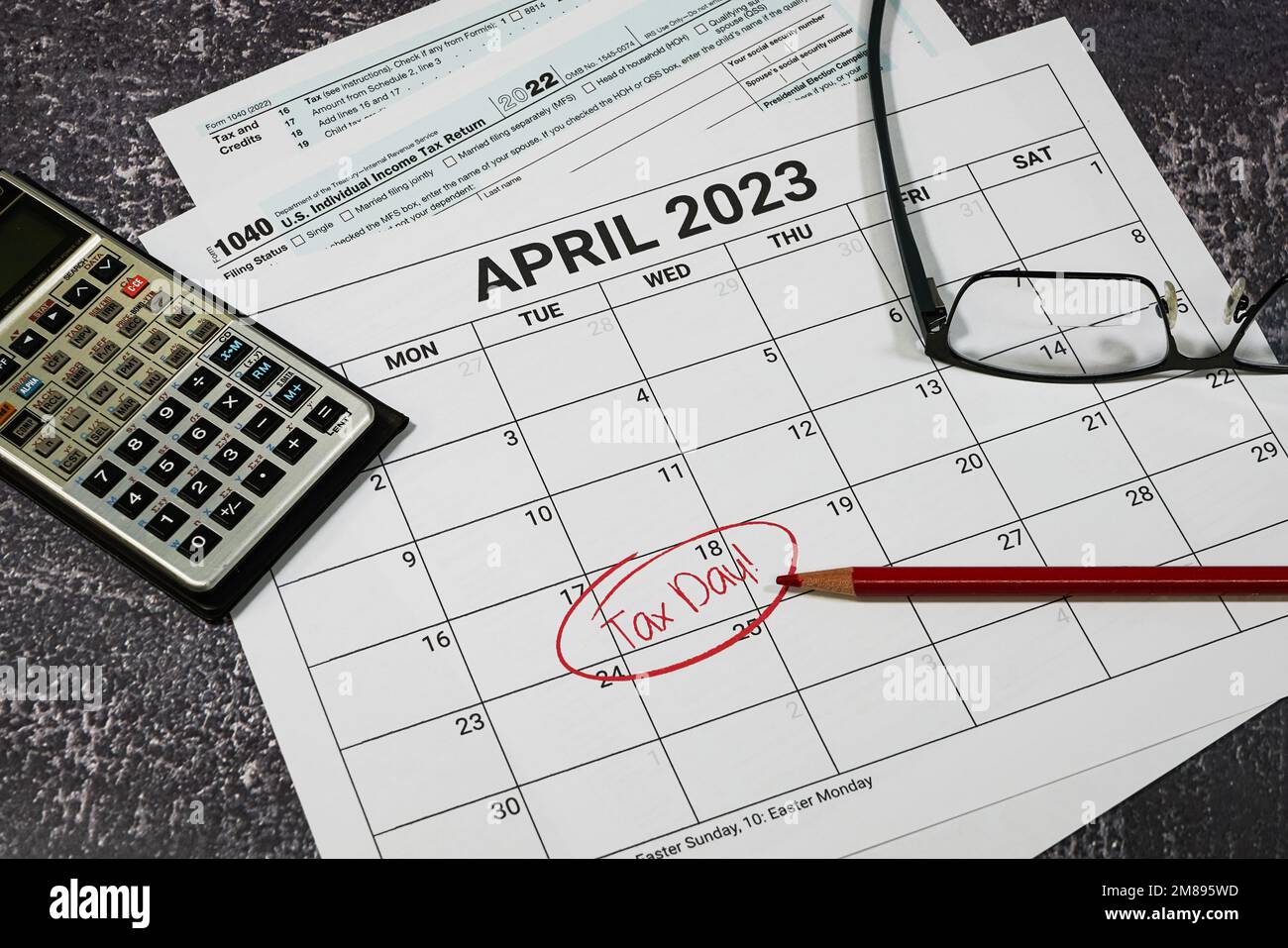 2023 US tax day calendar reminder with tax forms calculator and glasses ...