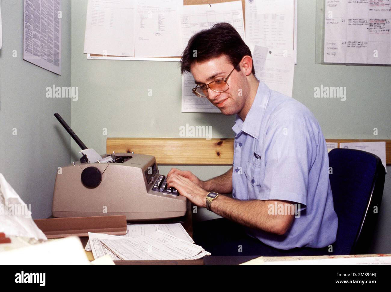 Religious Program SPECIALIST SEAMAN Apprentice Trent Waters types up a ...