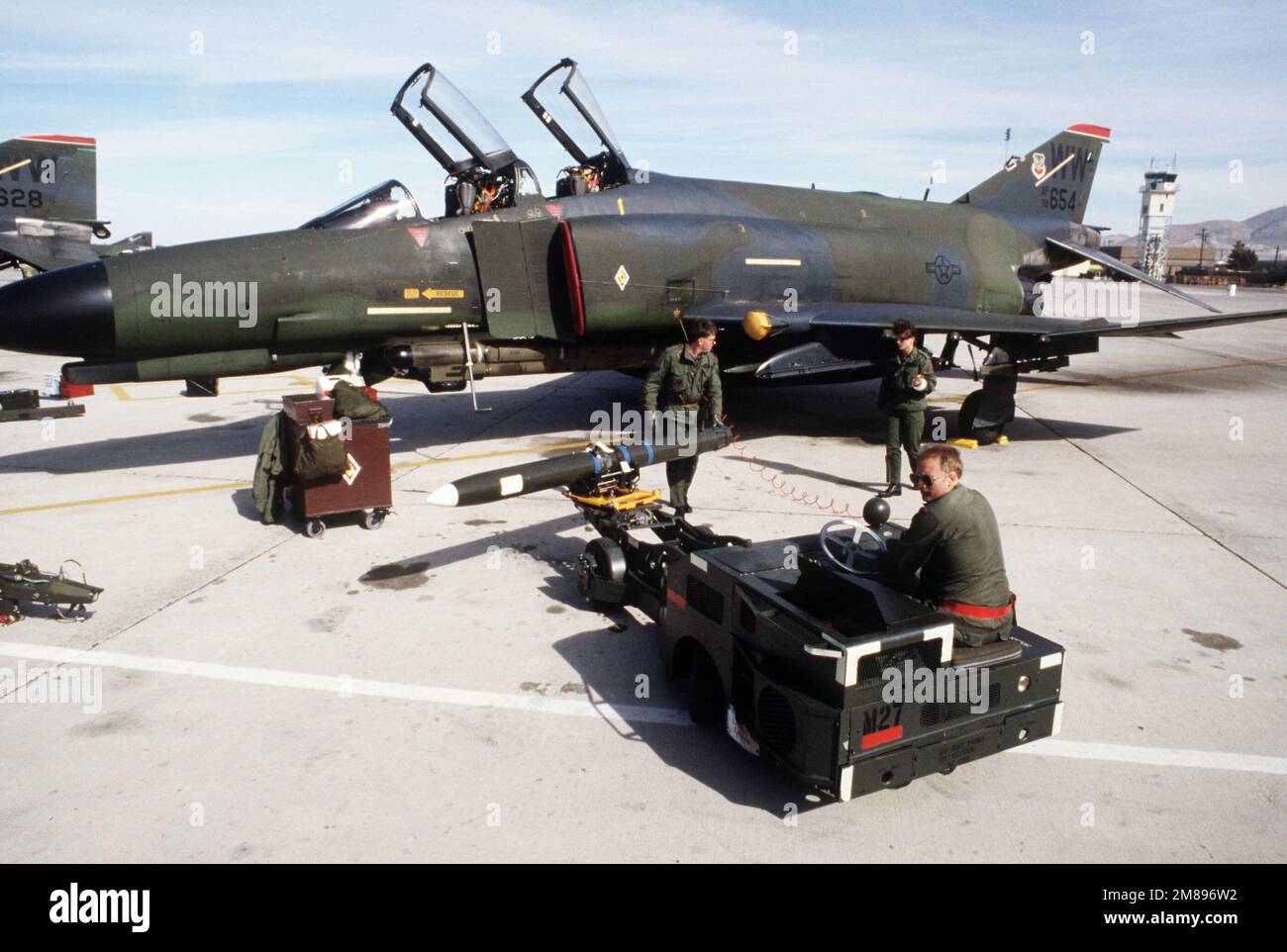 Members of a 37th Tactical Fighter Wing load crew use an MJ-1 weapons ...