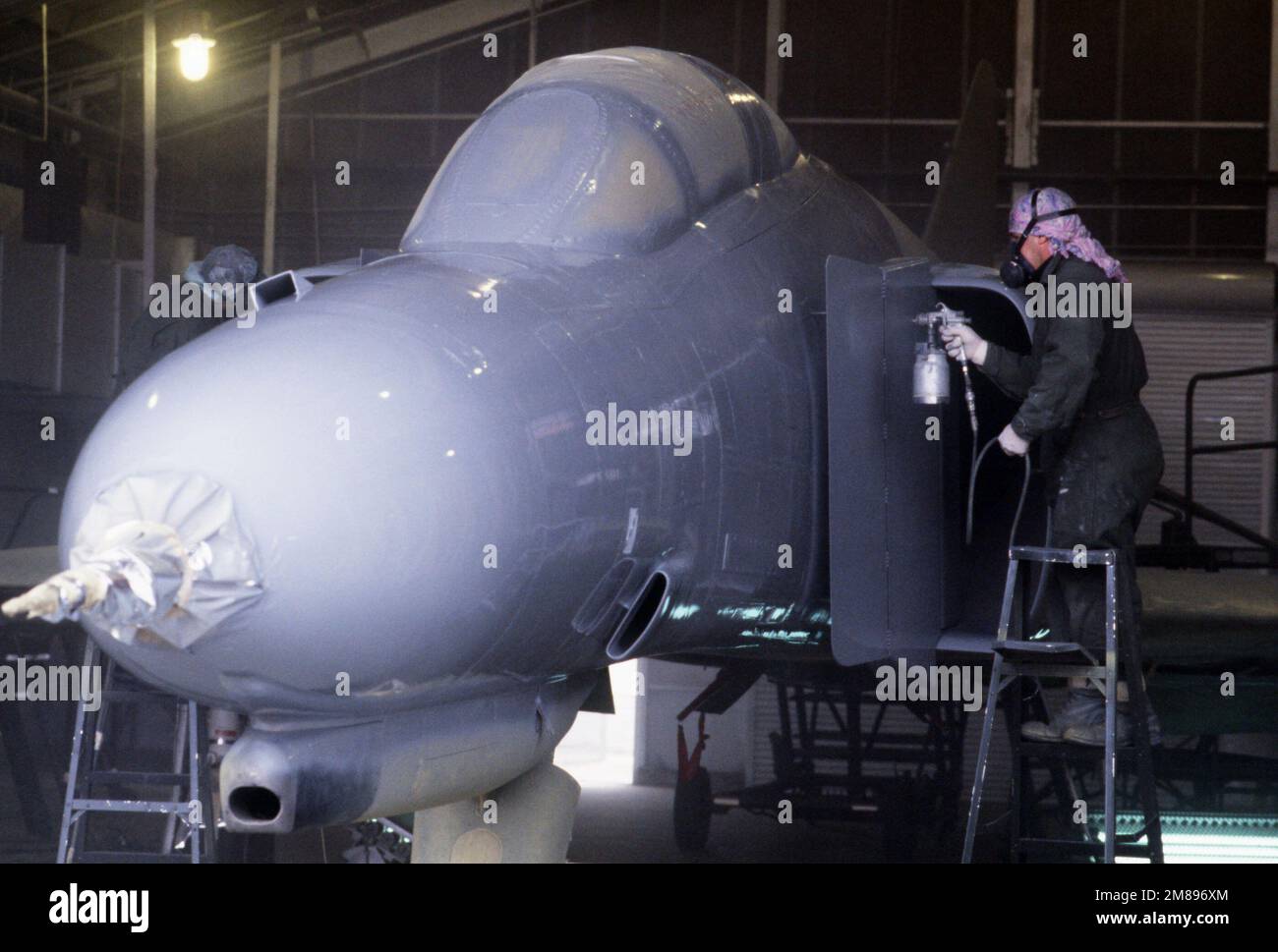 Two members of the 37th Equipment Maintenance Squadron paint an F-4E ...