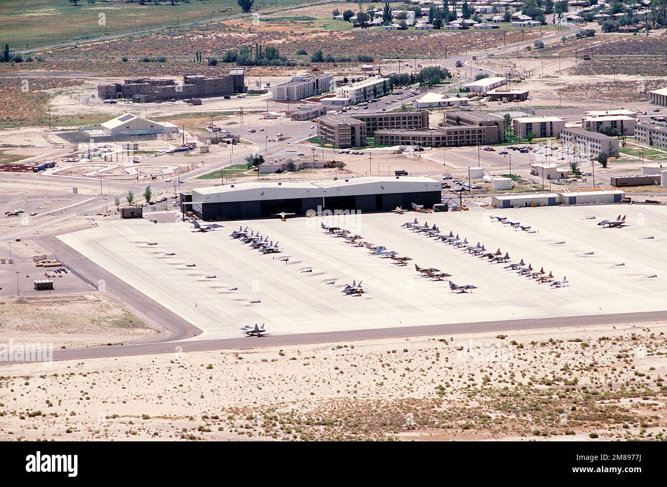 An aerial view of jets on the flight line, hangars, and buildings ...