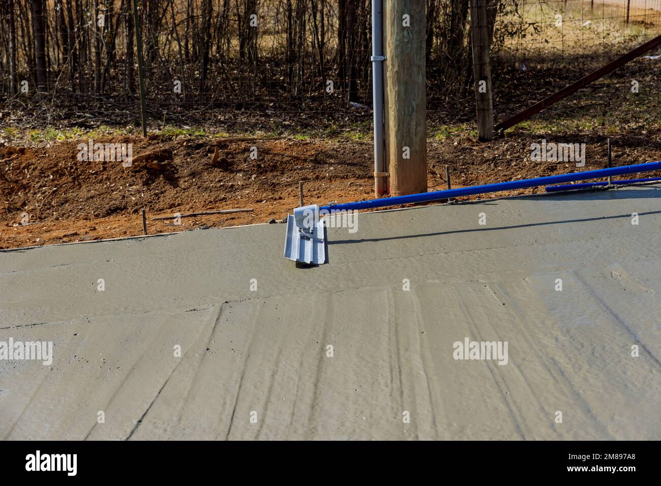In construction area worker is holding steel fresno trowel and ...