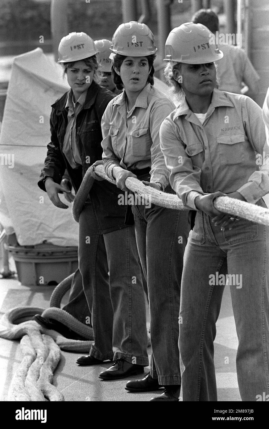 Female sailors haul rigging lines aboard the submarine tender USS MCKEE ...