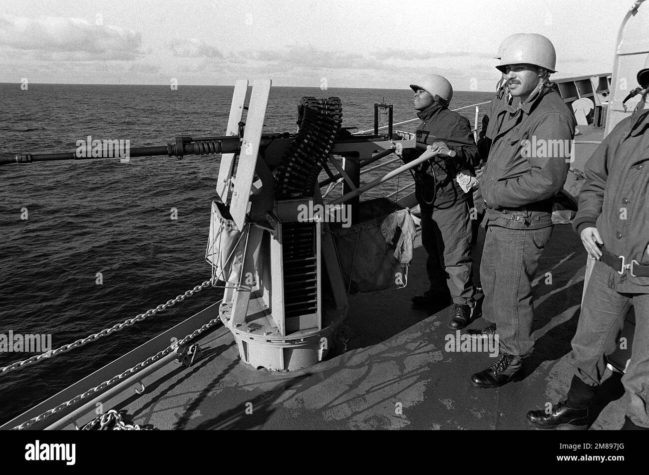 Crew members fire a Mark 67 20mm cannon aboard the submarine tender USS ...