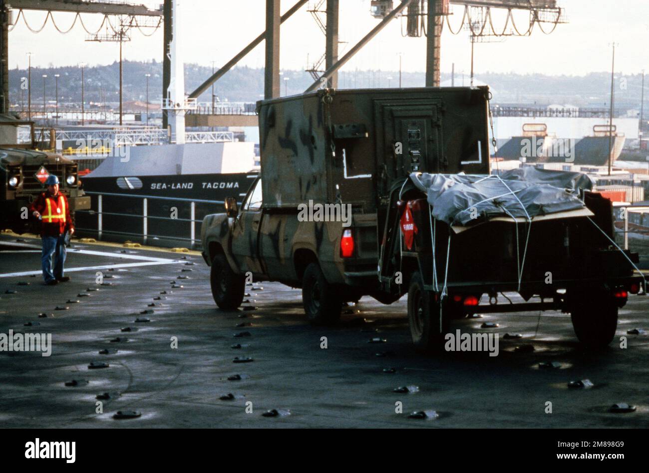 An M-880 1.25-ton cargo truck carrying a communications shelter is ...