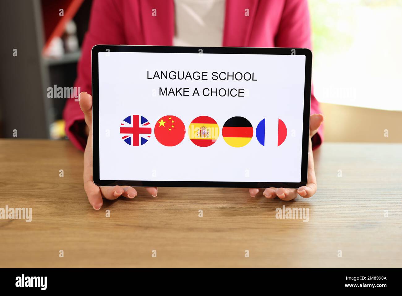 Woman holds tablet with text language school and offers to choose ...