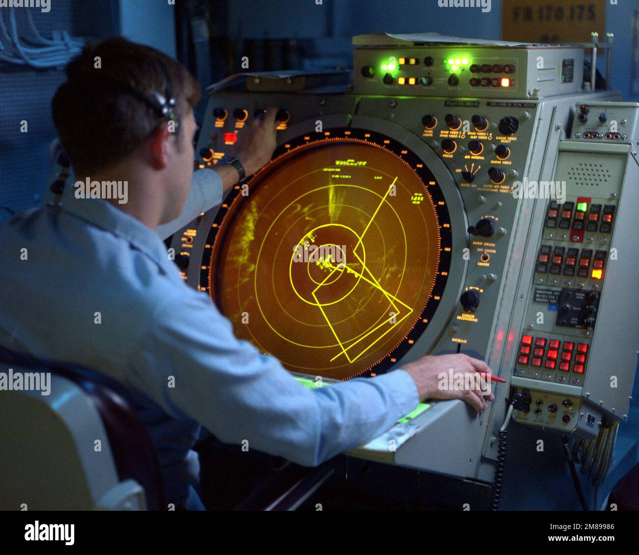 A crewman uses an Air Traffic Control Radar (ATCR) screen aboard the ...