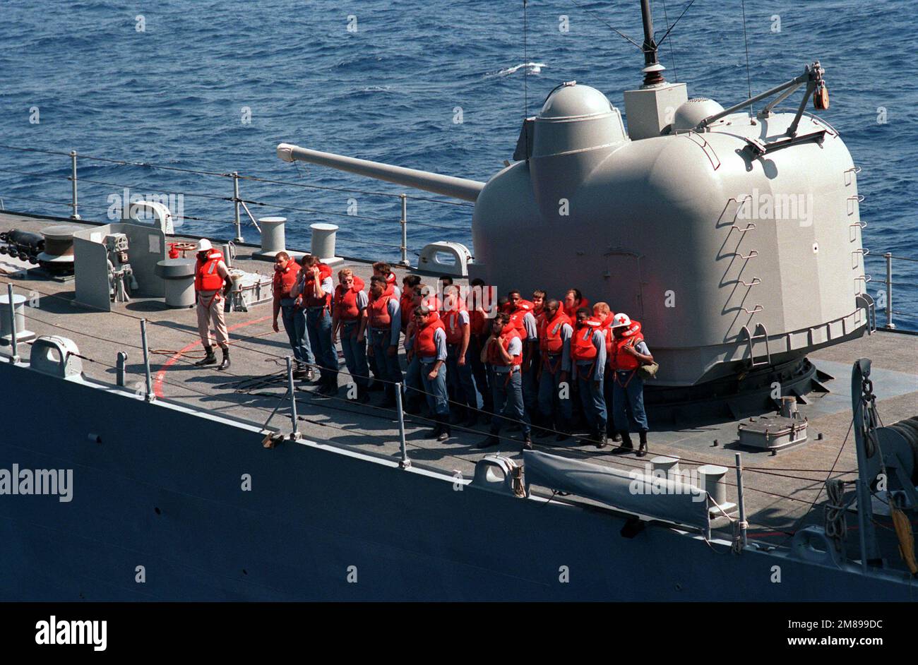 Members of the deck force underway replenishment unit stand near the ...