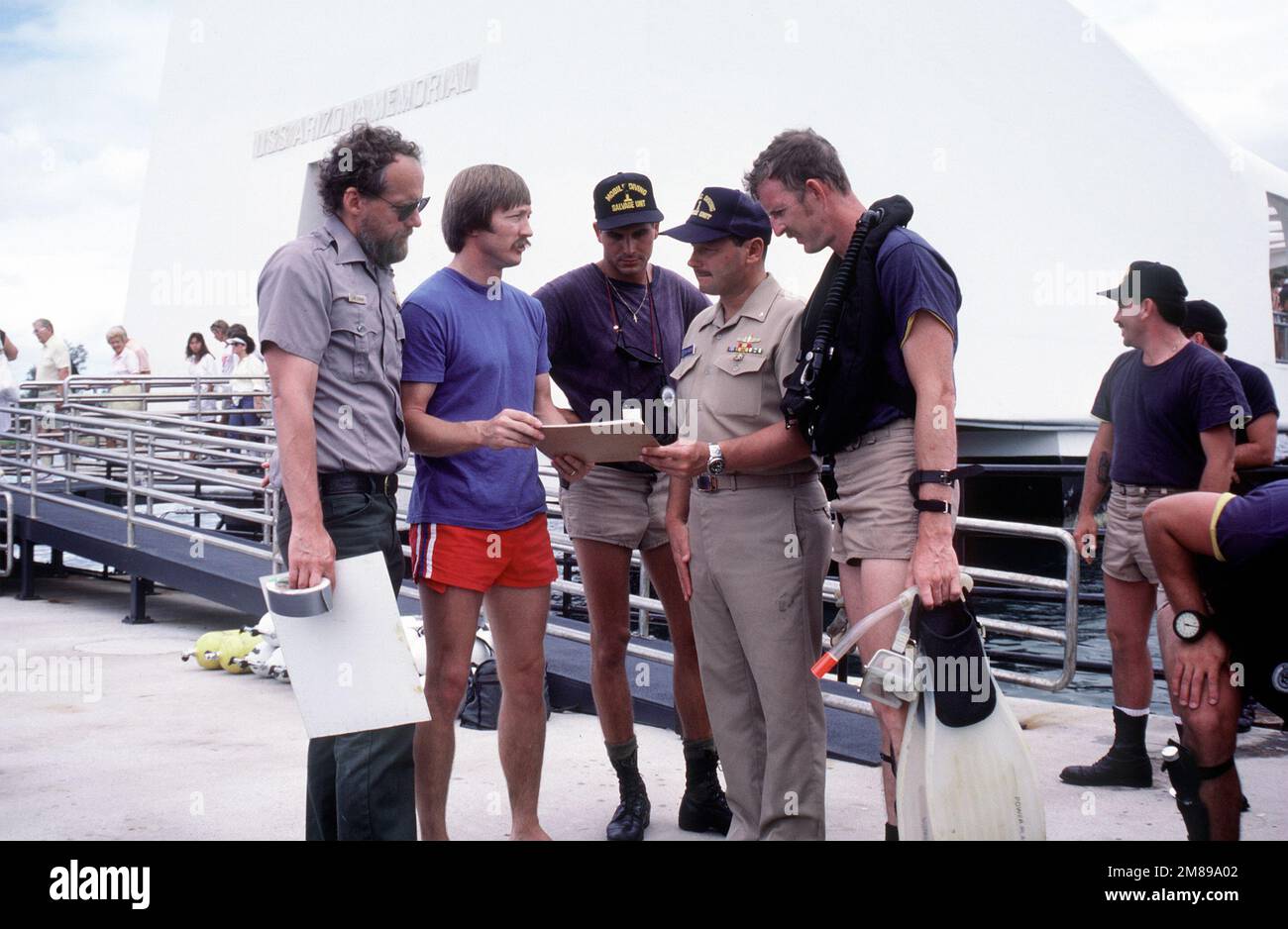 Navy divers from Mobile Diving Salvage Unit One review charts with U.S ...