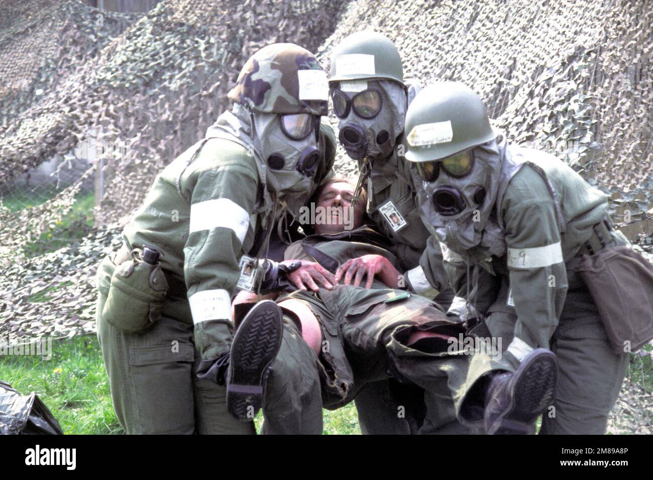 Military personnel in protective garb that includes M-17 chemical ...