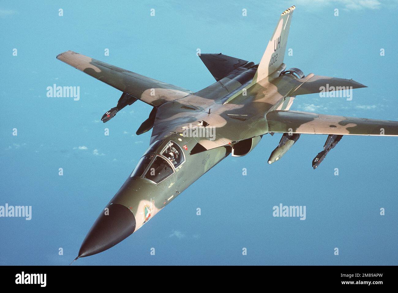 An air-to-air left front view of an F-111 aircraft during a refueling ...
