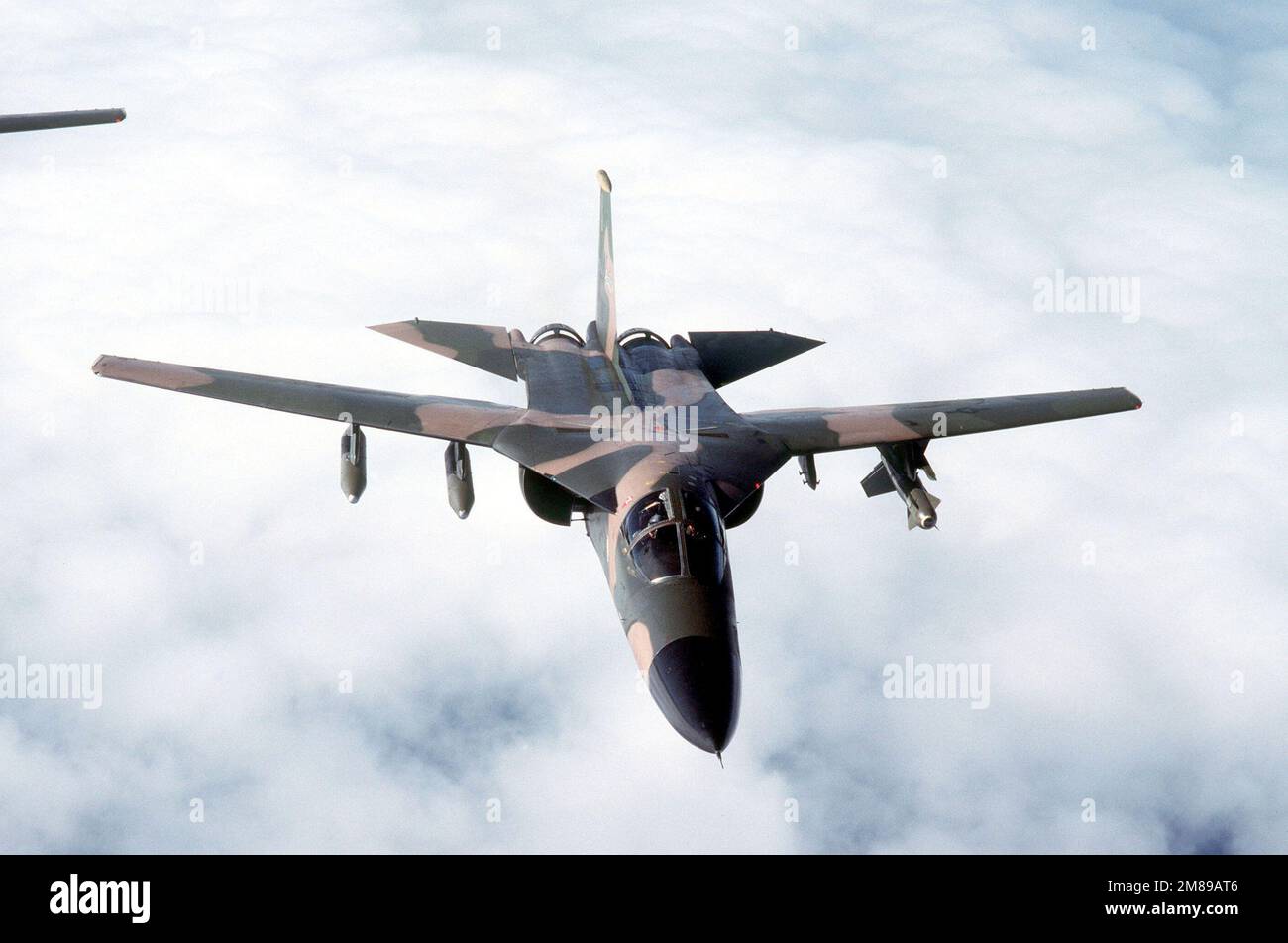 An air-to-air front view of an F-111 aircraft during a refueling ...