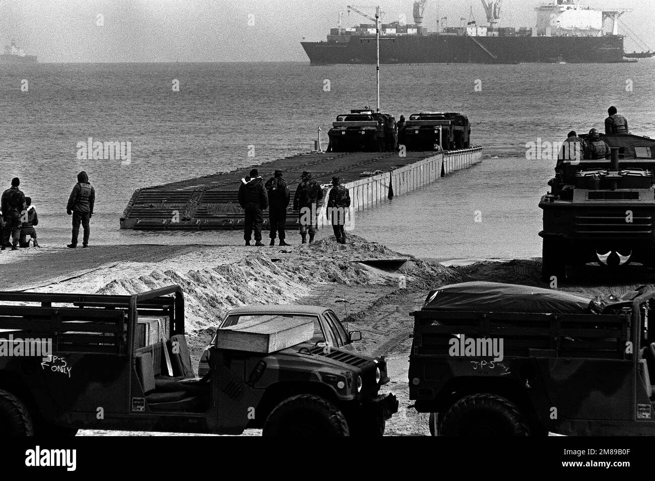 A floating causeway is used to ferry vehicles to the beach from the ...