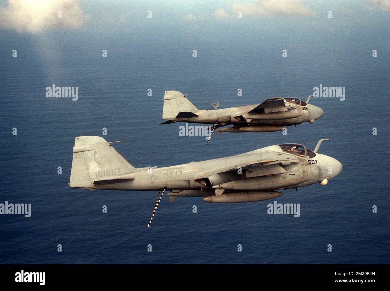 An air-to-air right side view of two A-6E Intruder aircraft flying in ...
