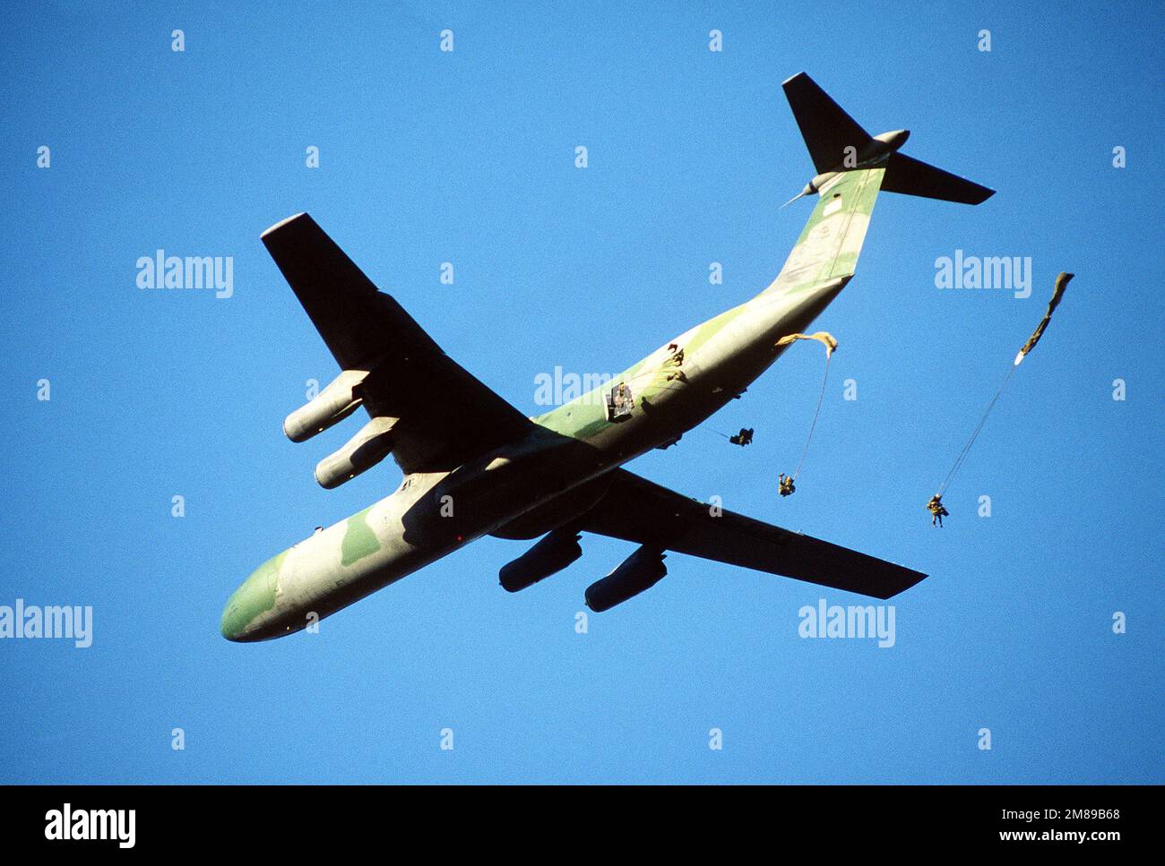 Members of the 82nd Airborne Division jump from a C-141B Starlifter ...