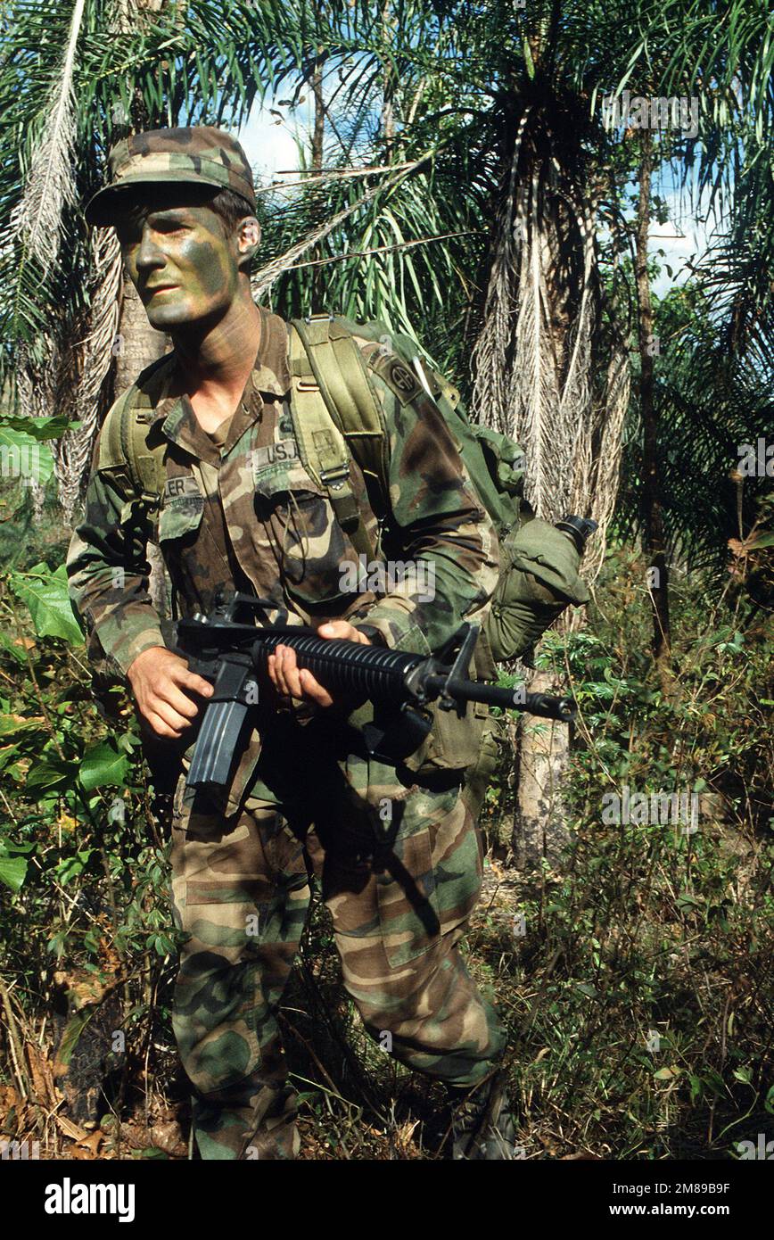 A member of the 82nd Airborne Division, armed with an M16A2 rifle ...