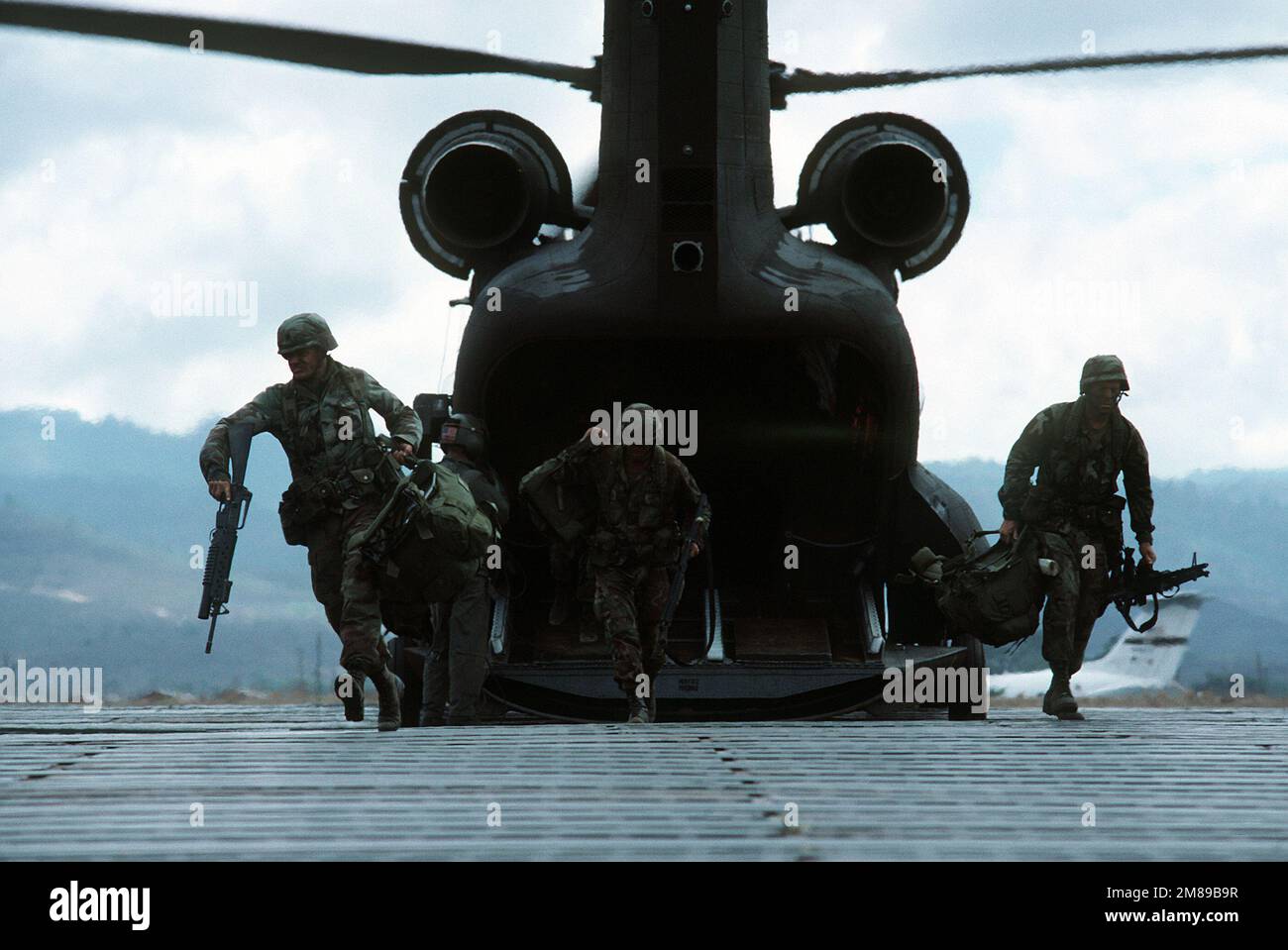 Members of the 82nd Airborne Division are deployed in the field by a CH ...