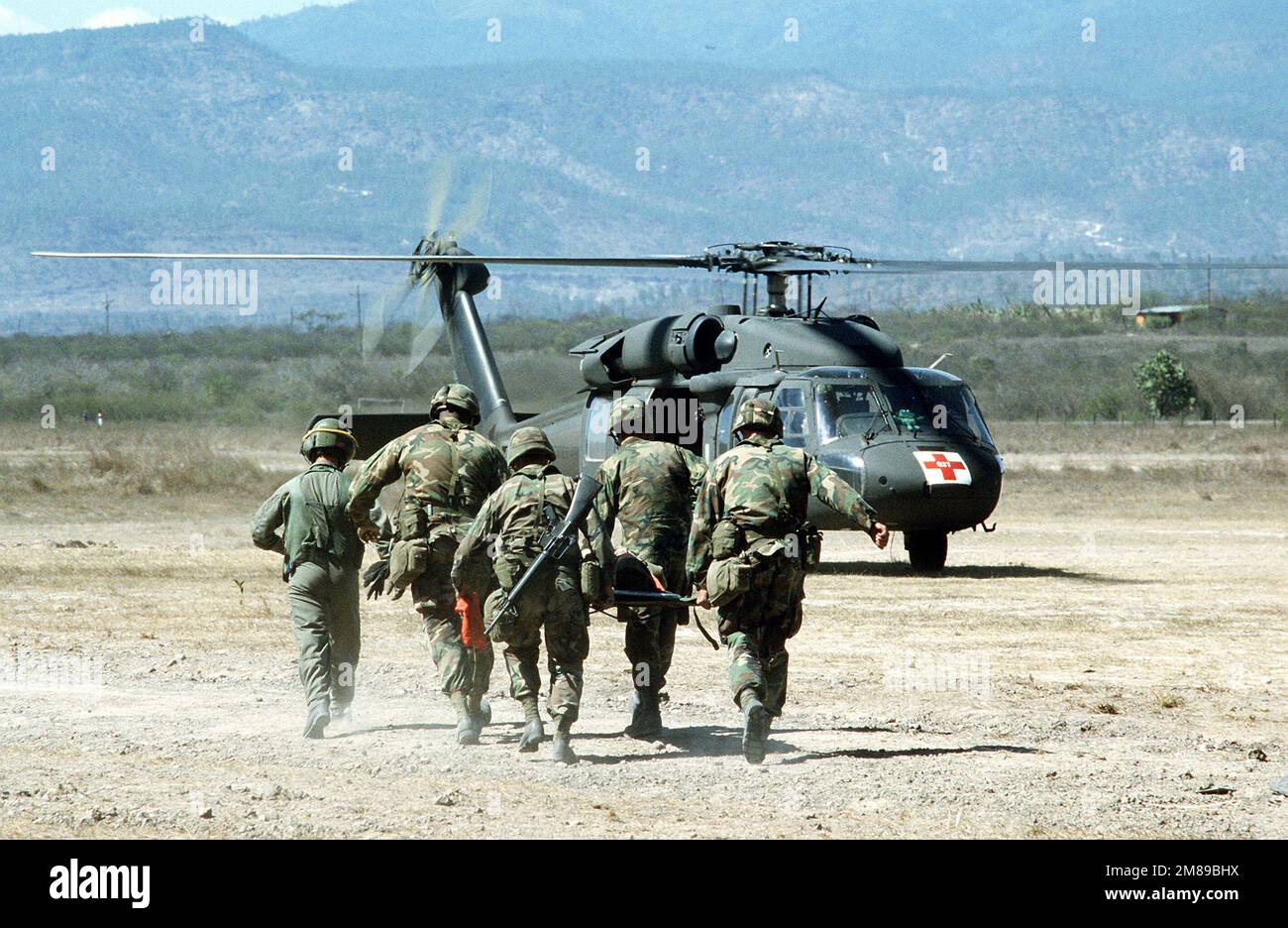 Soldiers transport a litter carrying an injured member of the 82nd ...