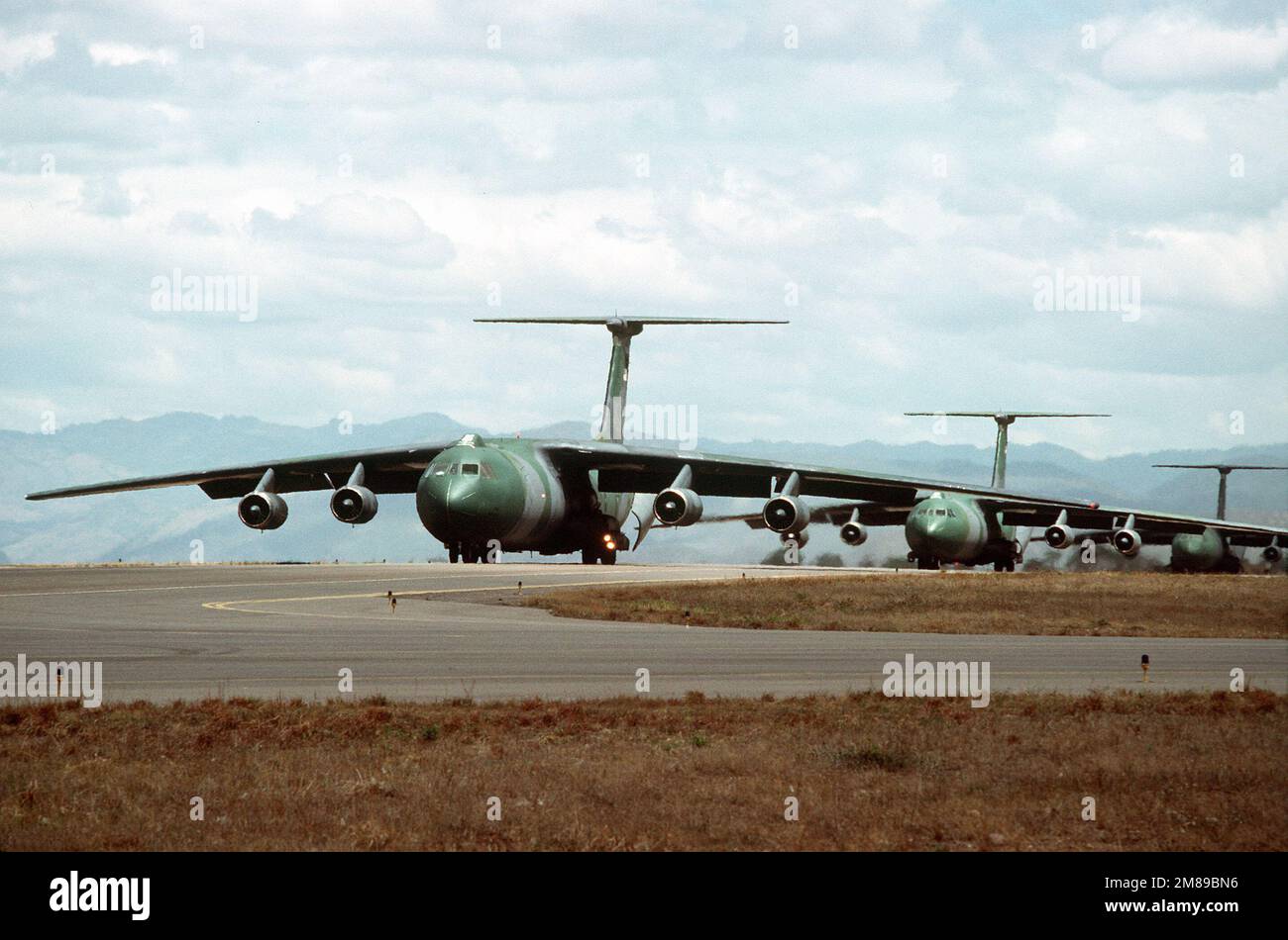 C-141B Starlifter aircraft carrying U.S. soldiers taxi along the flight ...