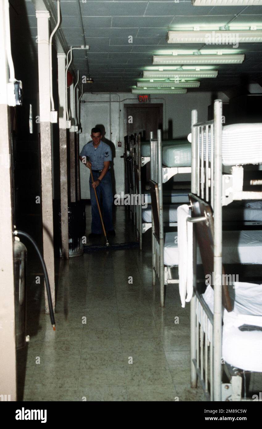 A petty officer sweeps the deck inside Bachelor Enlisted Quarters (BEQ ...