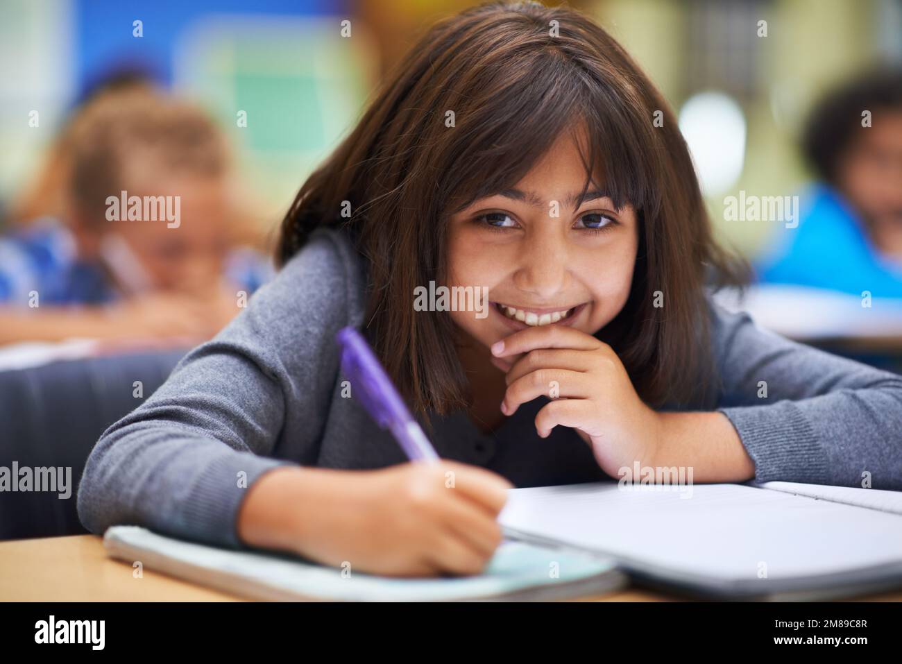 I love learning. Portrait of a young girl working on her schoolwork in ...