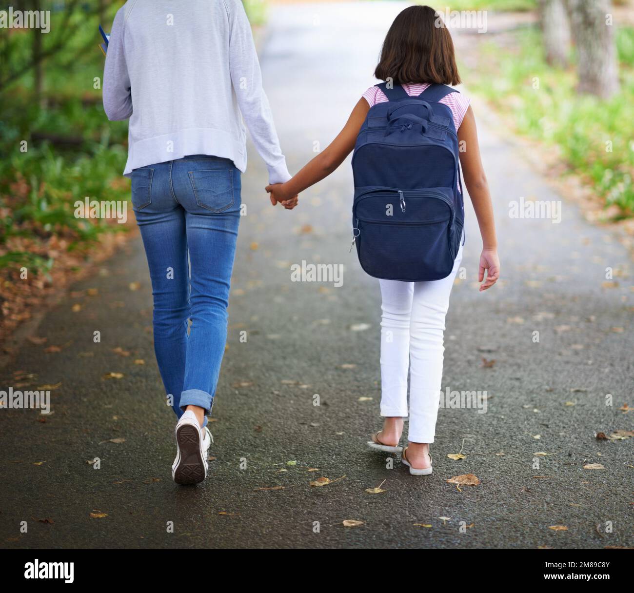 Walking to school. Rear view of a teacher walking her student to school Stock Photo - Alamy