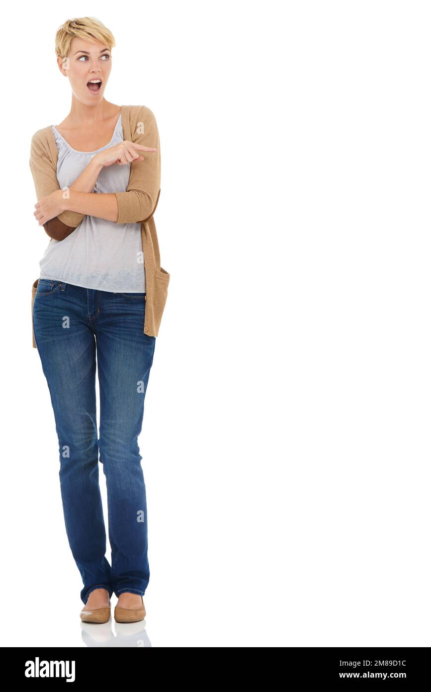 This is such a deal. Full length of a surprised young woman pointing ...
