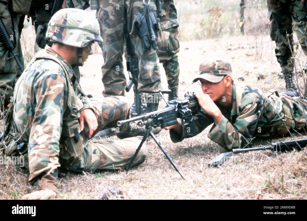 A member of the 82nd Airborne Division teaches a Honduran soldier how ...