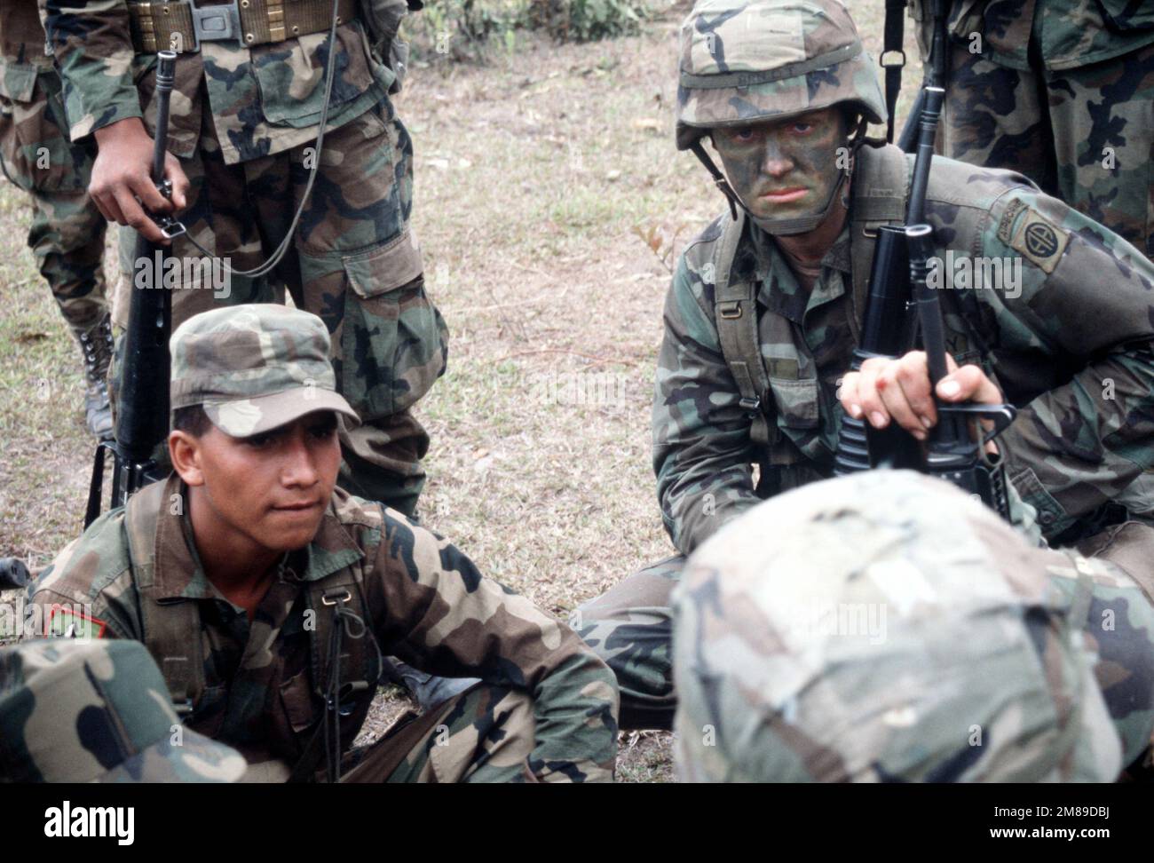 A Honduran soldier talks with several members of the 82nd Airborne ...