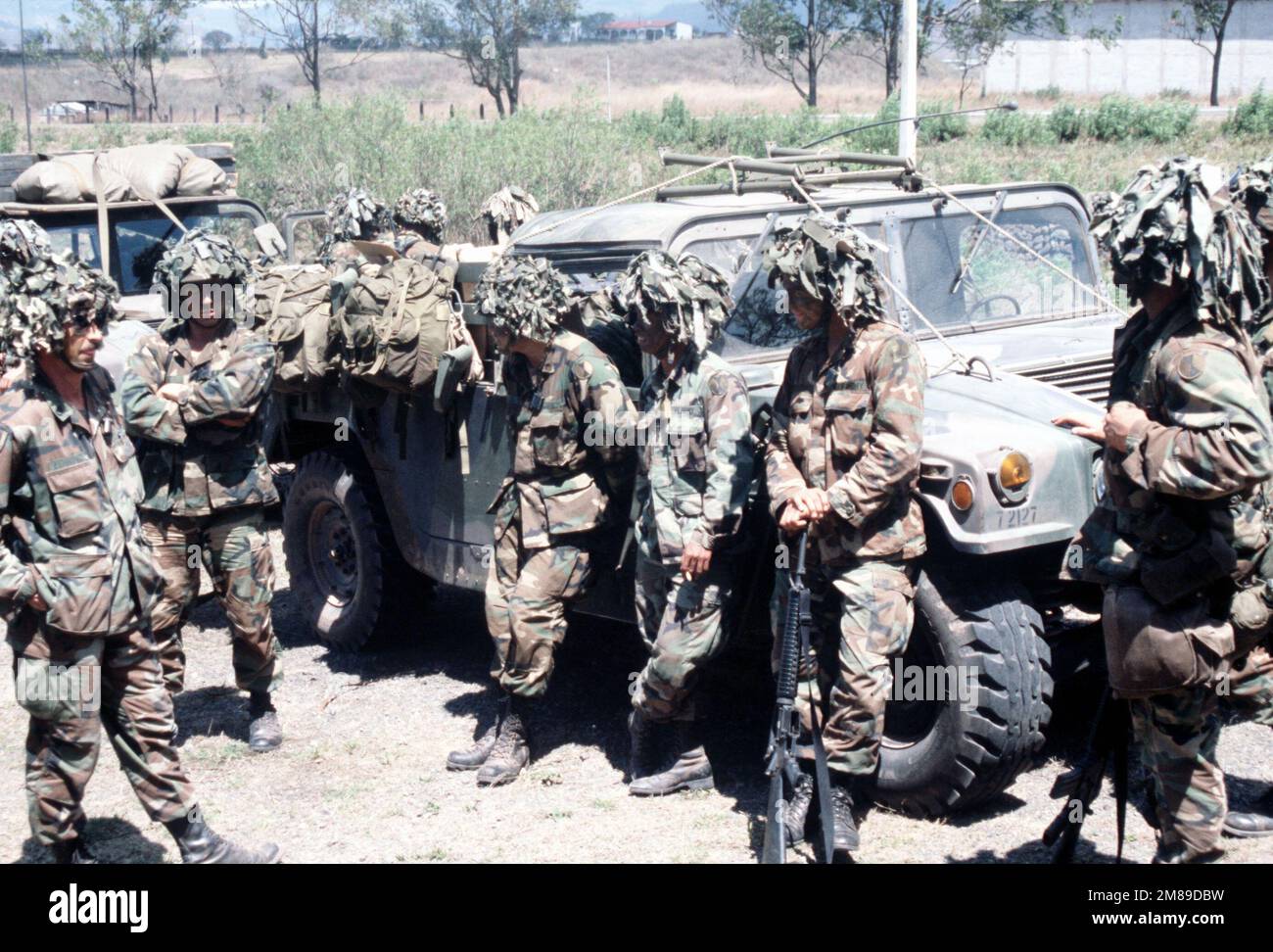 Several 7th Infantry Division soldiers stand around an M998 high ...