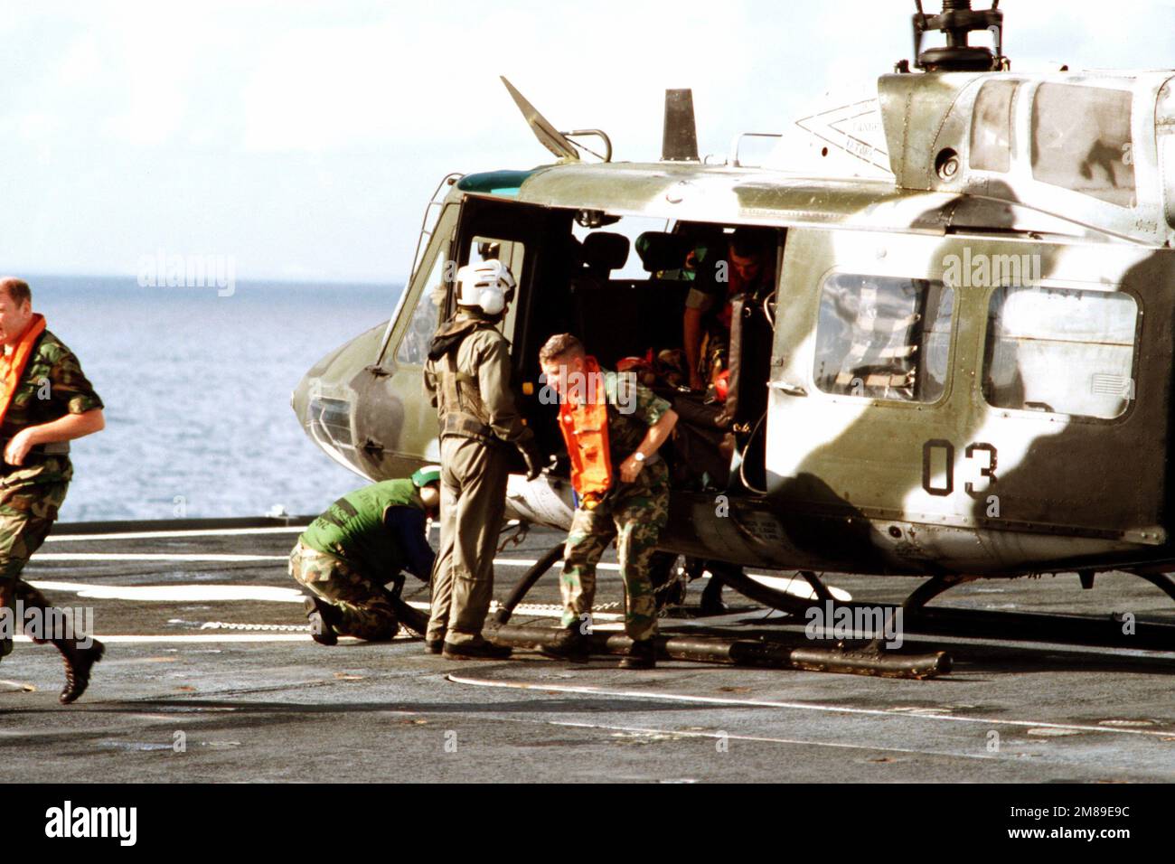 Passengers disembark from a Marine Utility/Attack Helicopter Squadron ...