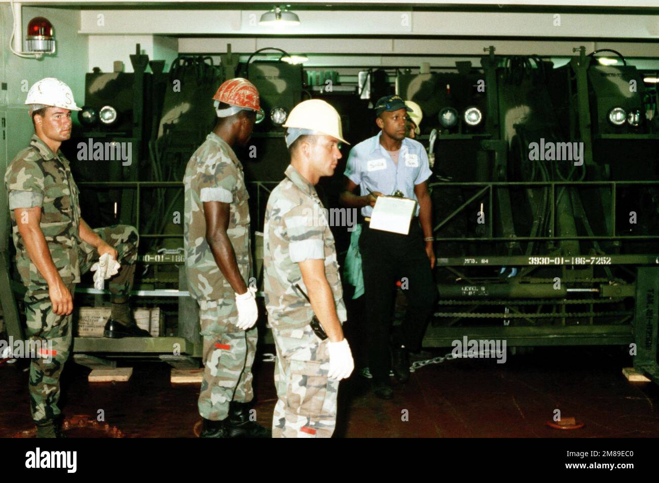 Marines aboard the aviation logistic ship USNS WRIGHT (T-AVB 3) look ...