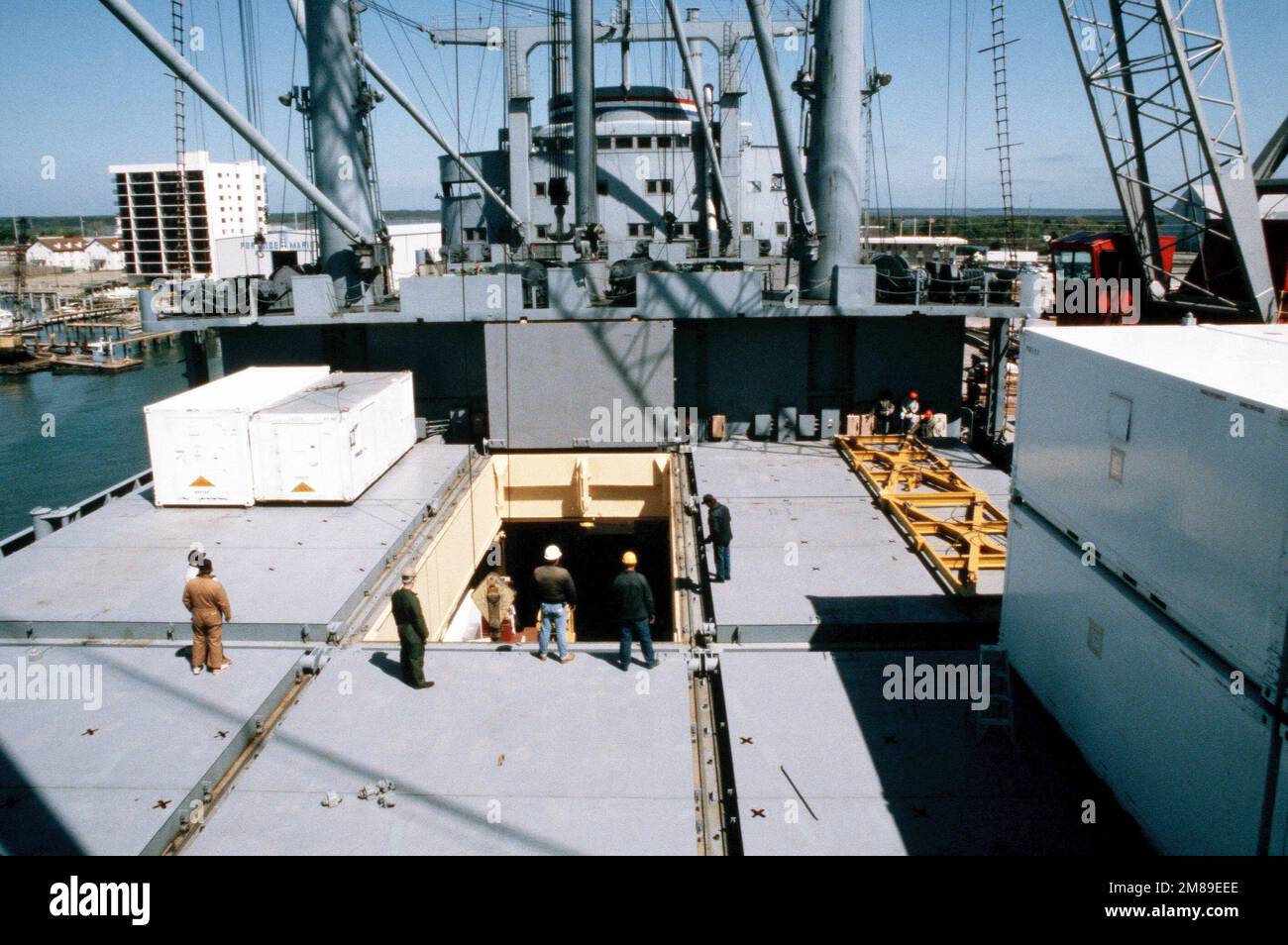 Equipment is lowered into a cargo hold aboard the aviation logistic ...