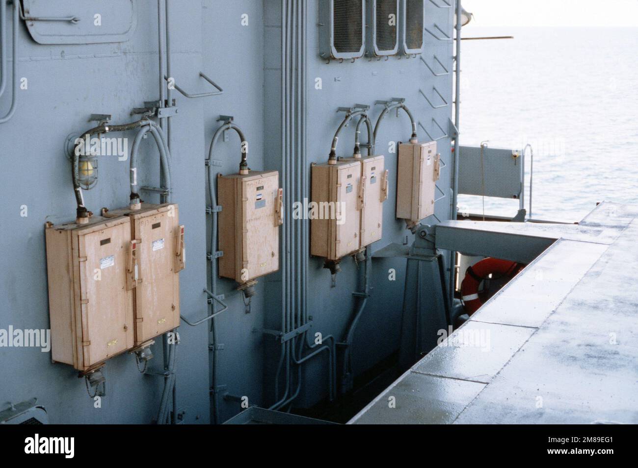 A view of several electrical junction boxes mounted on a bulkhead ...
